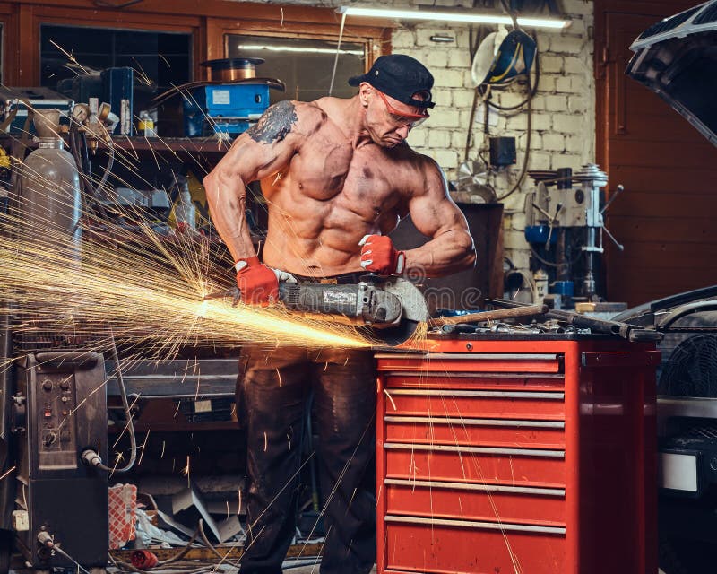 A man in a garage. stock photo. Image of garage, repairing - 108373256