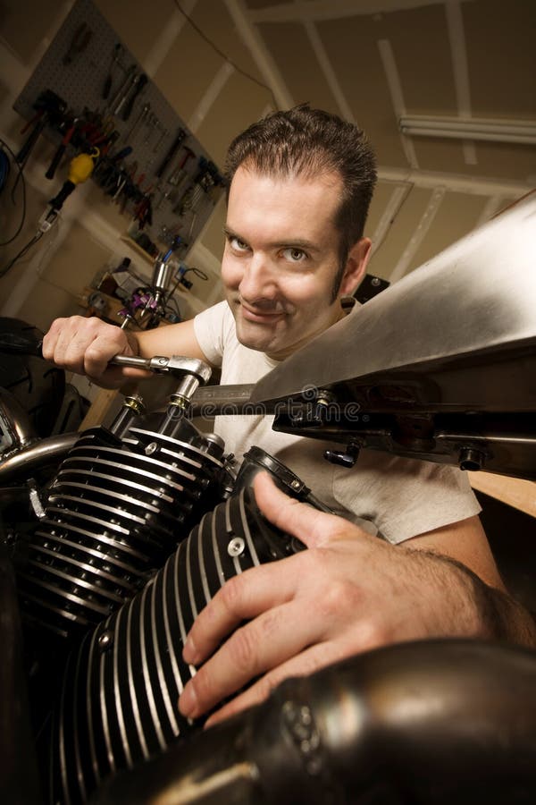 Man in Garage Working on Motocycle Stock Image - Image of work, adult ...