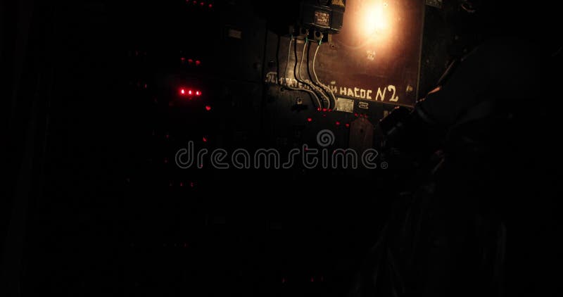 Man in a Gas Mask and Overalls Shines a Flashlight on the Remote ...