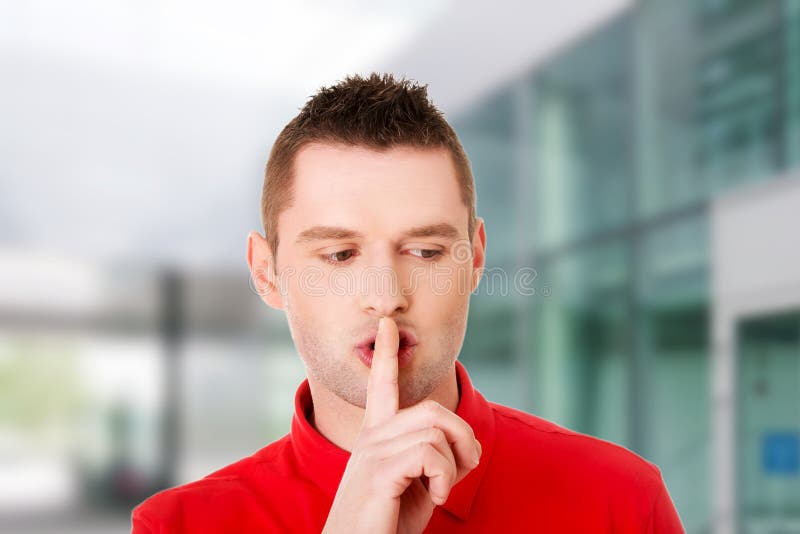 Man gesturing to be quiet stock photo. Image of beige - 47069104