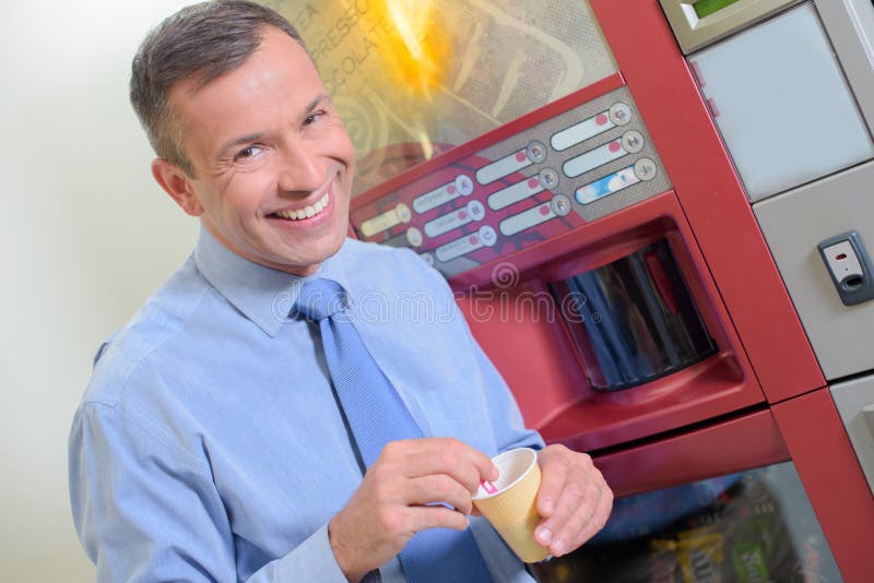 Man Getting Coffee from Vending Machine Stock Image - Image of machine ...