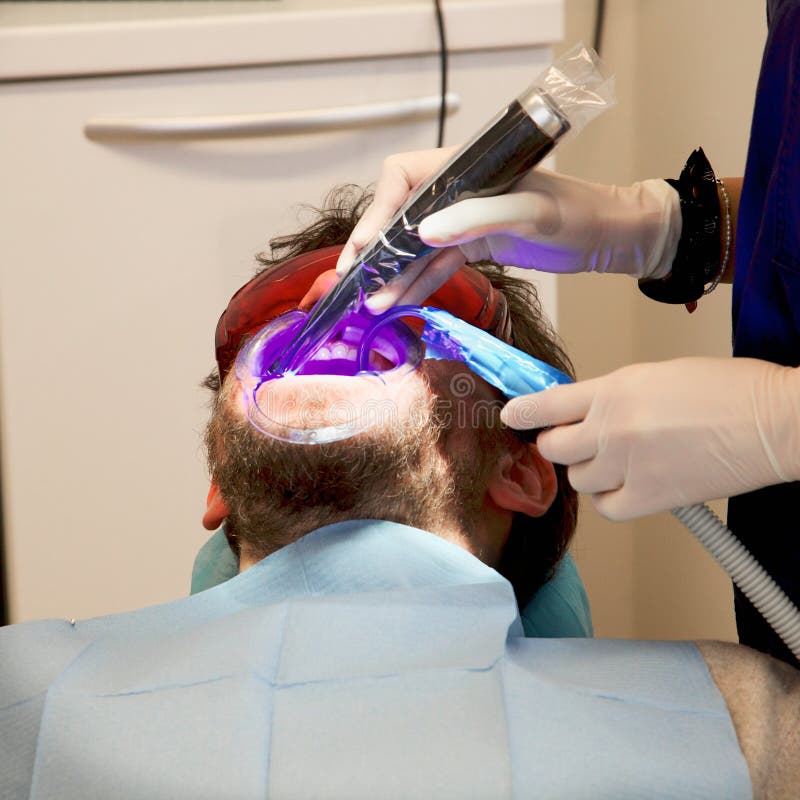 Man Getting Dental Surgery and Laser Treatment Stock Image - Image of ...