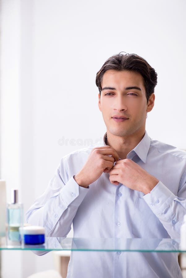 The Man is Getting Dressed Up for Work in Bathroom Stock Photo - Image ...