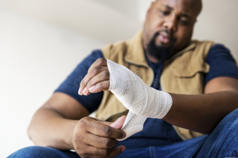 A Man Getting Injured Putting on Bandages Stock Photo - Image of ...