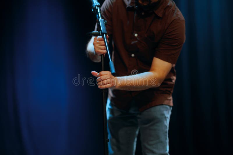 Technician Adjusts and Arranges a Microphone on Stage Stock Photo ...