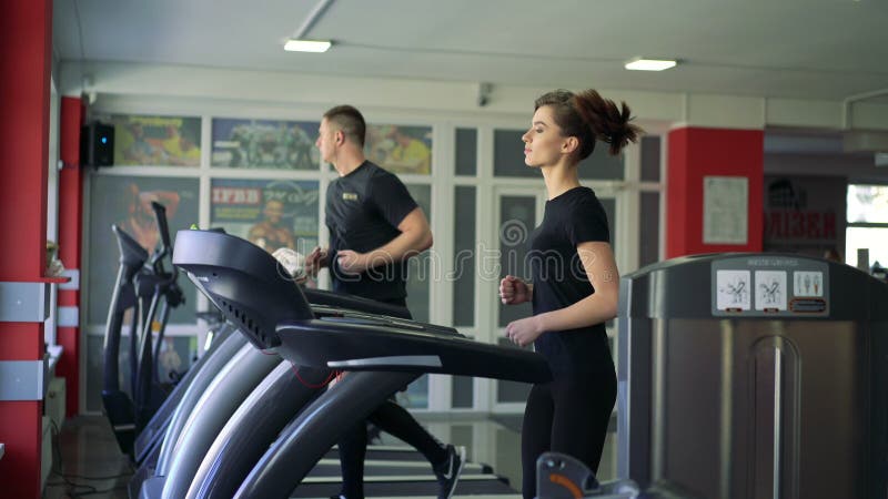 A Man and a Girl Running on the Treadmill at the Gym. 4k Stock Footage ...