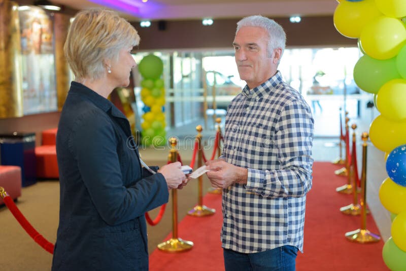 Man giving entrance ticket stock photo. Image of entertainment - 87665538