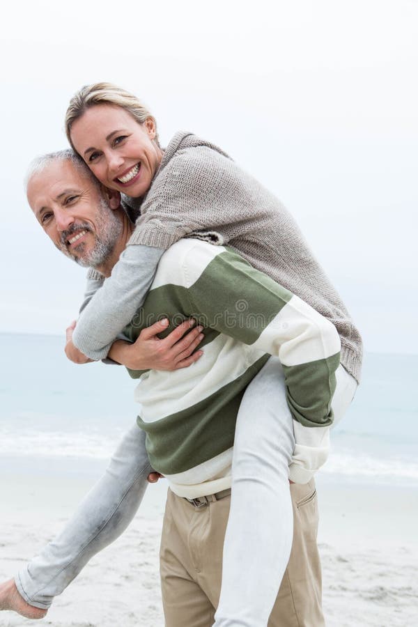 Man Giving His Partner a Piggy Back Stock Image - Image of caucasian ...