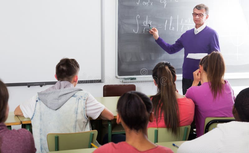 Man giving a math lesson stock photo. Image of class - 78949346
