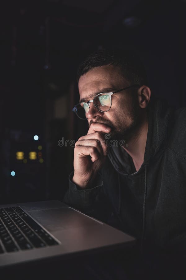 A Man with Glasses Works at a Computer Late at Night Stock Photo ...