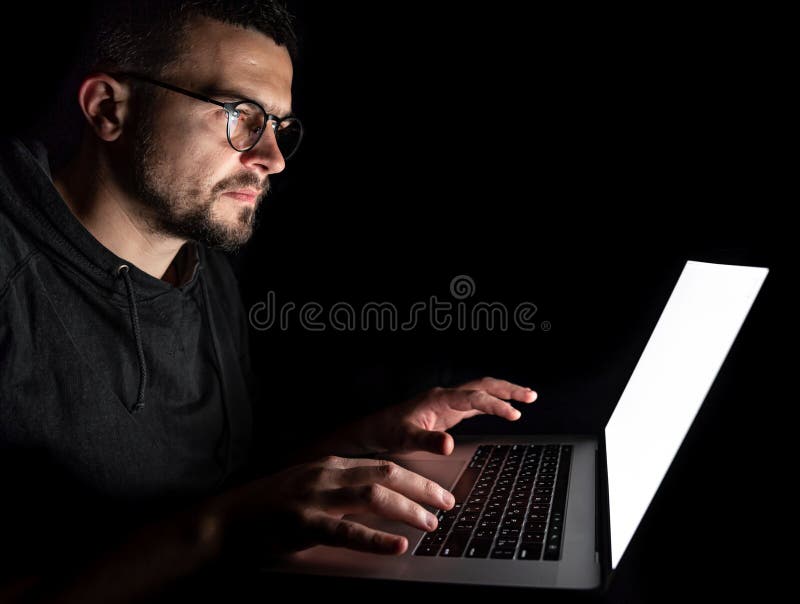 A Man with Glasses Works at a Laptop in the Dark Editorial Image ...