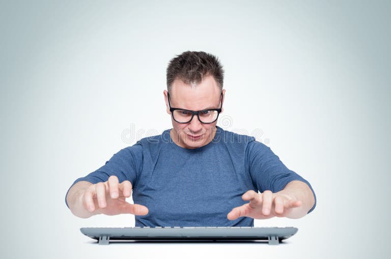Man in Glasses Working at the Computer, His Hands Hover Over the ...