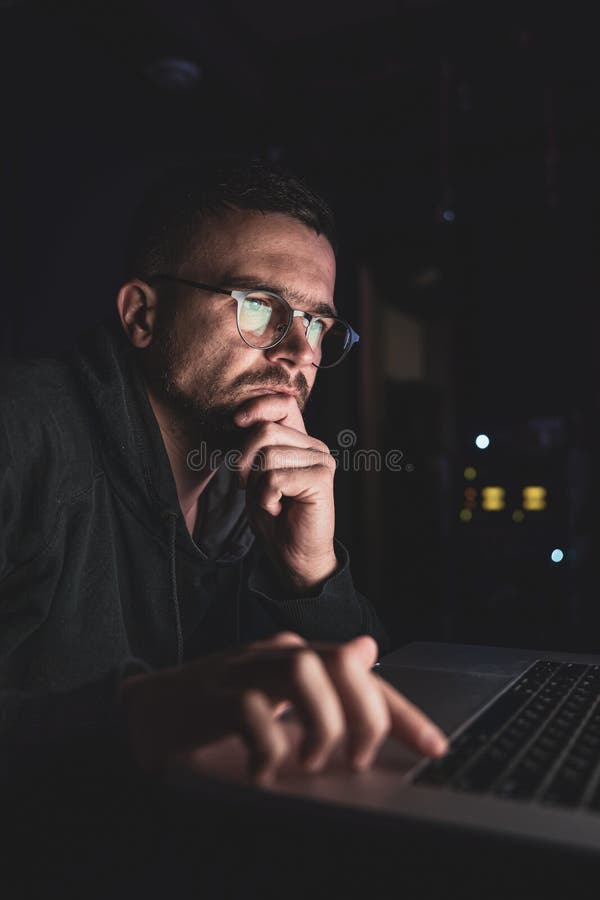 A Man with Glasses Works at a Computer Late at Night Stock Image ...