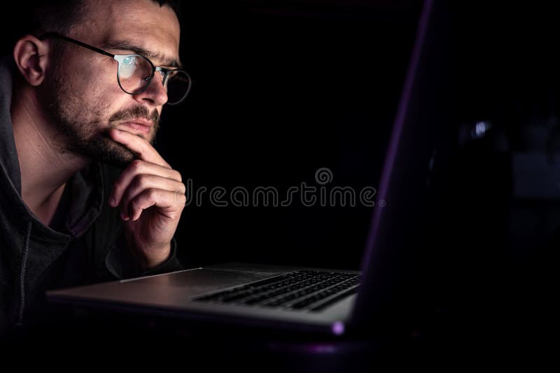 A Man with Glasses Works at a Computer Late at Night Stock Photo ...