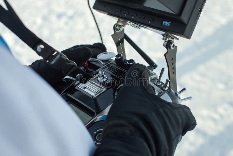 A Man in Gloves is Holding a Professional Remote Control with a Screen ...