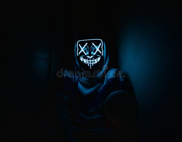 Man in Glowing Mask Sitting in the Corner Stock Image - Image of light ...