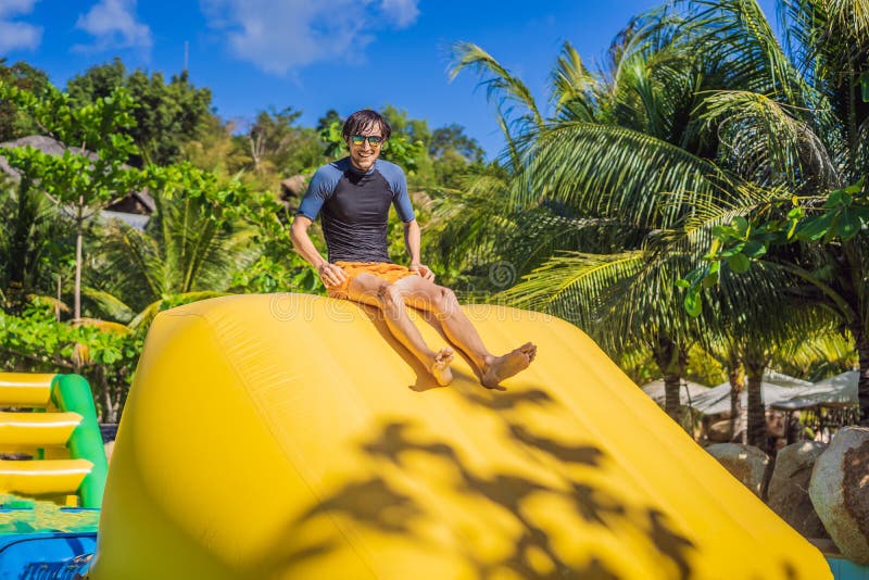 Man Go through an Inflatable Obstacle Course in the Pool Stock Image ...