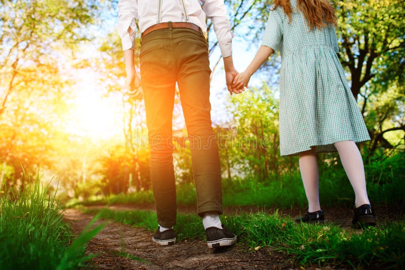 Man Goes with His Girlfriend on the Road, Low Angle, Back View Stock ...
