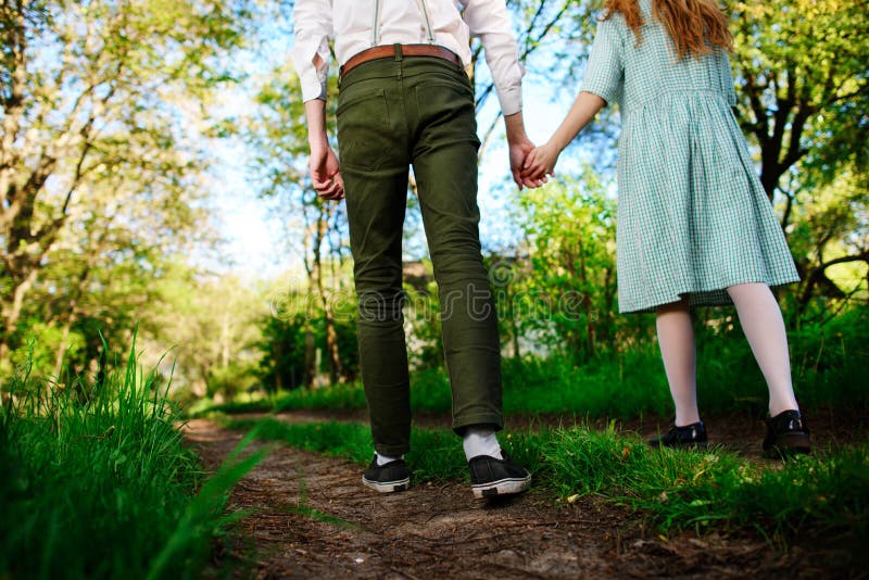 Man Goes with His Girlfriend on the Road, Low Angle, Back View Stock ...