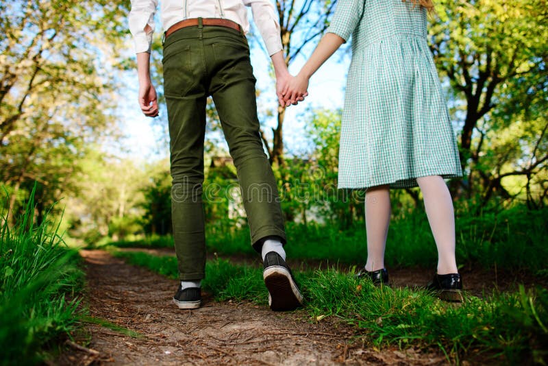 Man Goes with His Girlfriend on the Road, Low Angle, Back View Stock ...