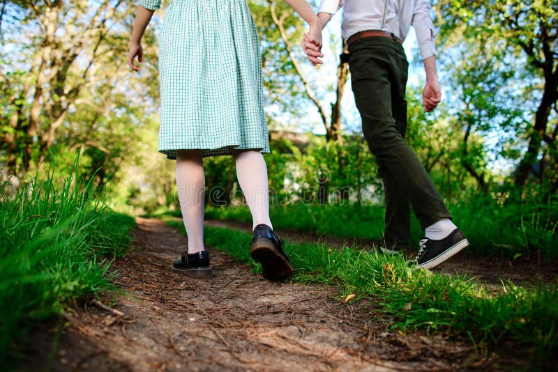 Man Goes with His Girlfriend on the Road, Low Angle, Back View Stock ...