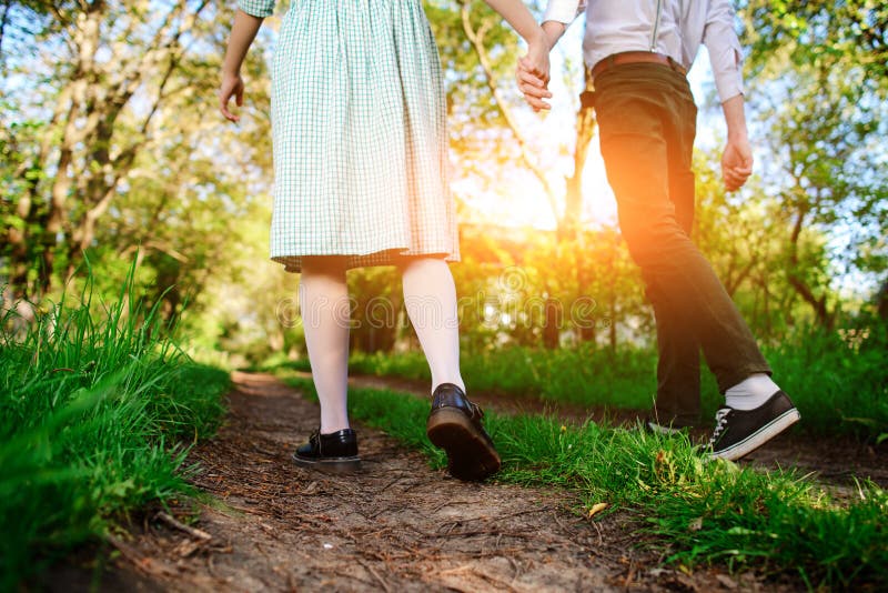 Man Goes with His Girlfriend on the Road, Low Angle, Back View Stock ...