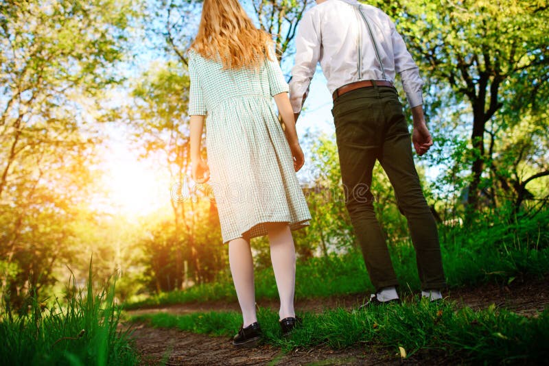Man Goes with His Girlfriend on the Road, Low Angle, Back View Stock ...