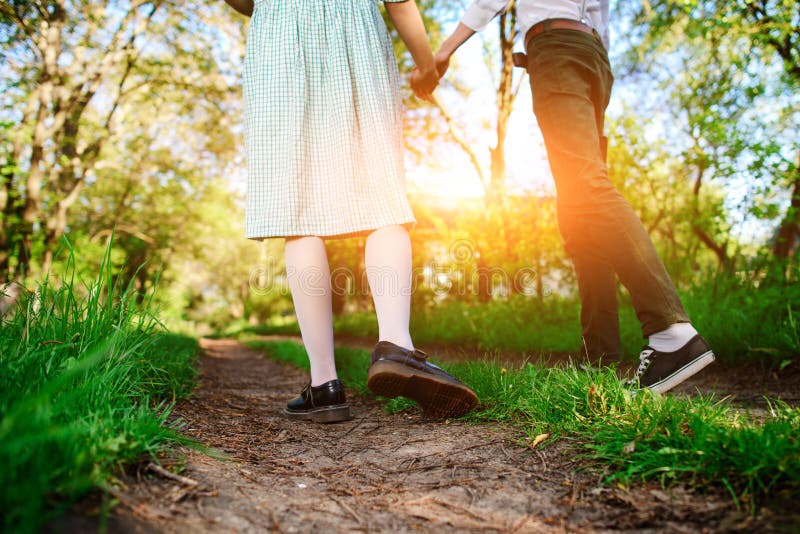 Man Goes with His Girlfriend on the Road, Low Angle, Back View Stock ...