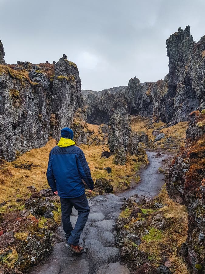 Man Going Down a Path between Volcanic Mountains in Iceland, Hell Stock ...