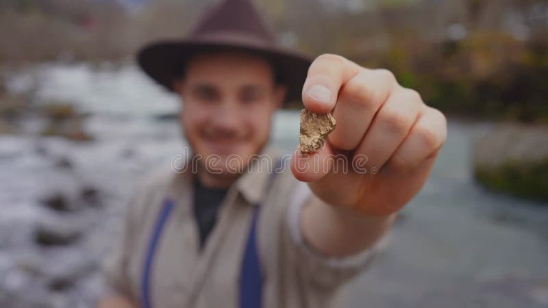 Man Gold Digger in a Hat Shows a Large Gold Nugget To the Camera Stock ...