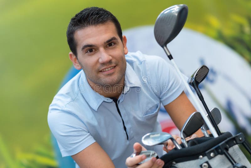 Man with golf club stock photo. Image of concentration - 148030600