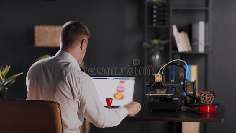 A Man Graphic Designer Sits by the Table, Uses Calipers and Measures ...