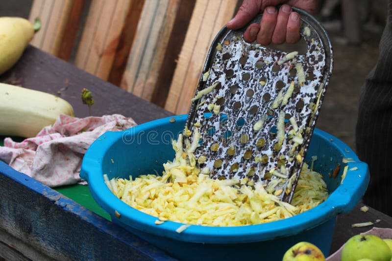 Man Grates a Squash. Hands Hold Grater and Vegetable Stock Photo ...