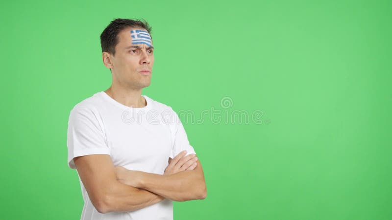 Man with Greek Flag Painted Looking Away with Serious Expression Stock ...