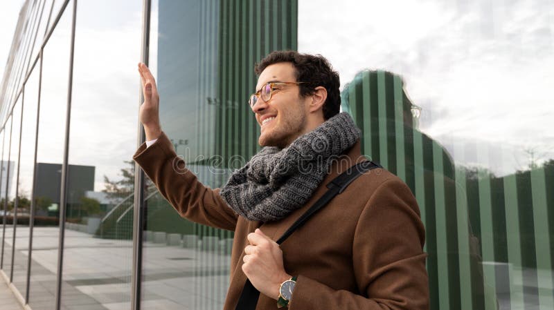 Man Greeting Someone Leaning on a Glass Panel Stock Photo - Image of ...