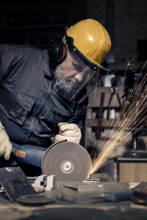 Man with grinder in action stock image. Image of metal - 133347051