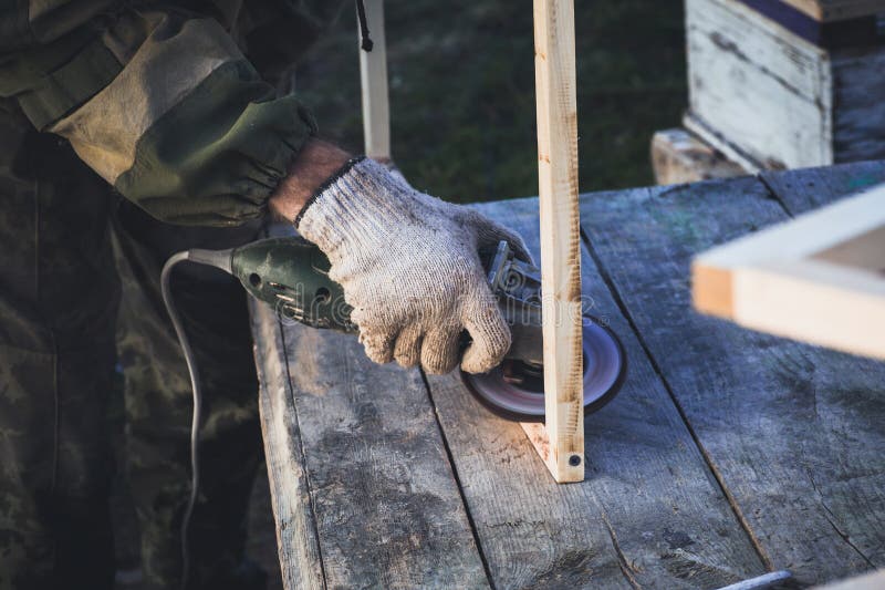 Man with Grinding Machine Makes Frame for Bees. Create Bee Frame with ...