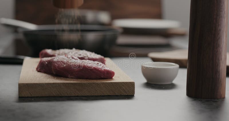 Man Grinding Pepper on Raw Beef Steak on Oak Board Stock Photo - Image ...