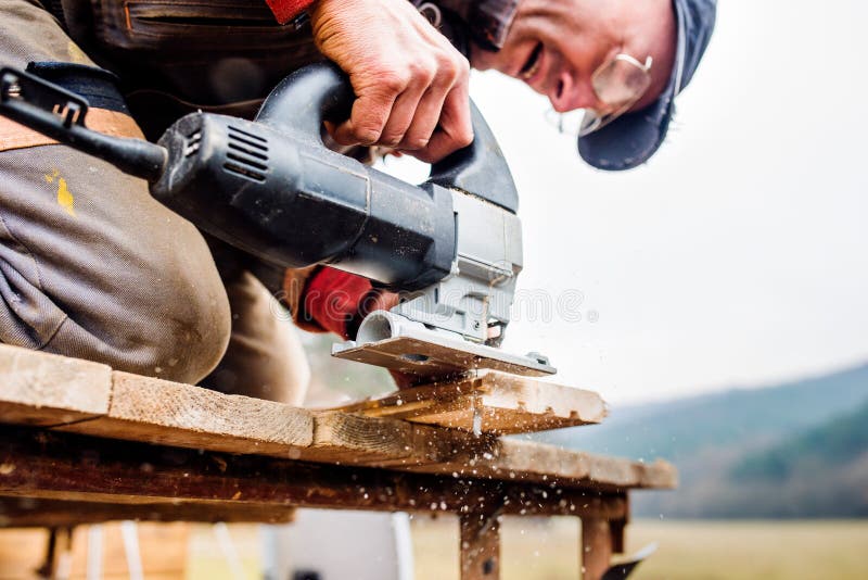 Man Grinding Planks of Wood for Home Construction. Stock Image - Image ...