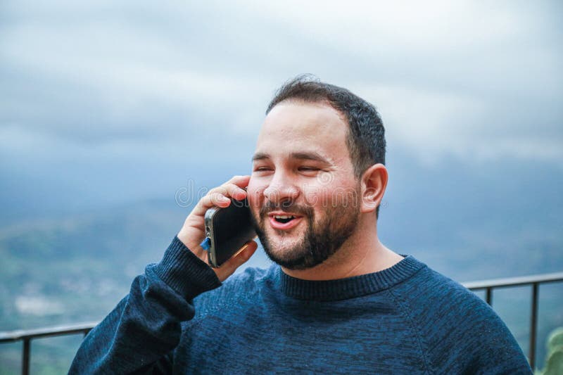Man Grins while Chatting Cheerfully on Phone Stock Photo - Image of ...