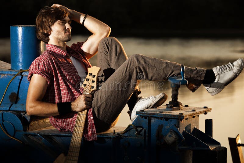 Man and Guitar at Sunset by the River Stock Photo - Image of body ...