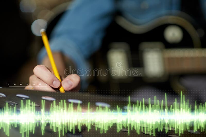 Man with Guitar Writing To Music Book at Studio Stock Photo - Image of ...
