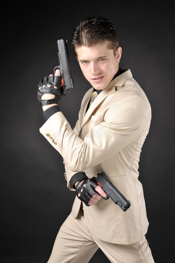 Attractive Man with a Gun Wearing a White Suit Stock Image - Image of ...