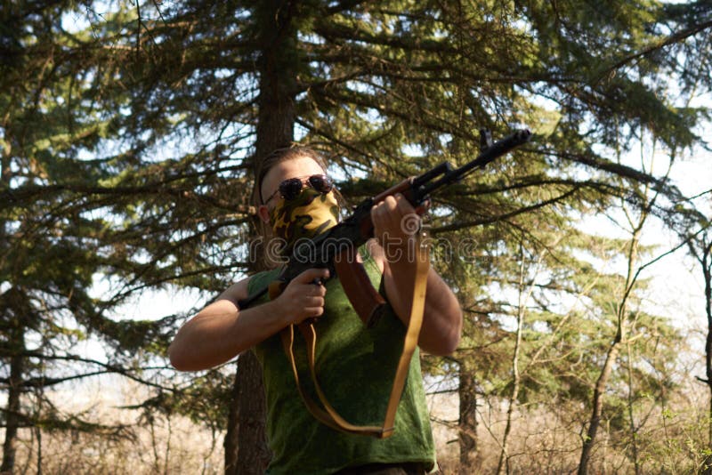 A Man with a Gun in a Forest Stock Image - Image of looking, sport ...