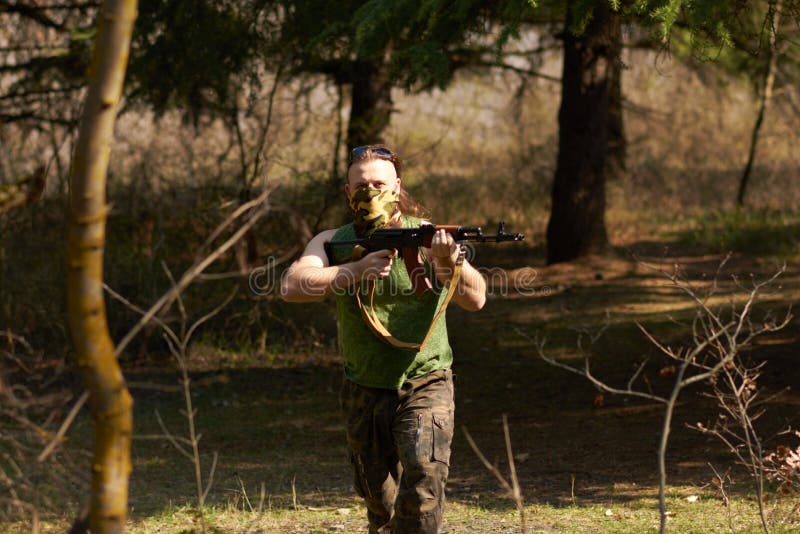 A Man with a Gun in a Forest Stock Image - Image of survival, rifle ...