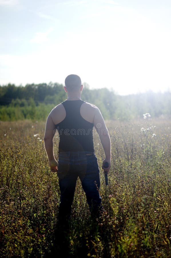 A Man with a Gun in His Hands.Back View Stock Photo - Image of snaper ...
