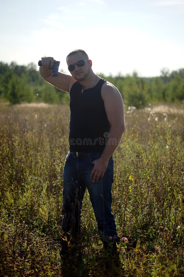 A Man with a Gun in His Hands.Back View Stock Photo - Image of snaper ...