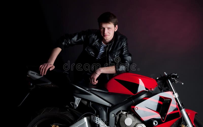 Handsome Man, Guy in Black Leather Jacket Sits on Motor Bike in Studio ... Handsome Man, Guy in Black Leather Jacket Sits on Motor Bike in Studio ...