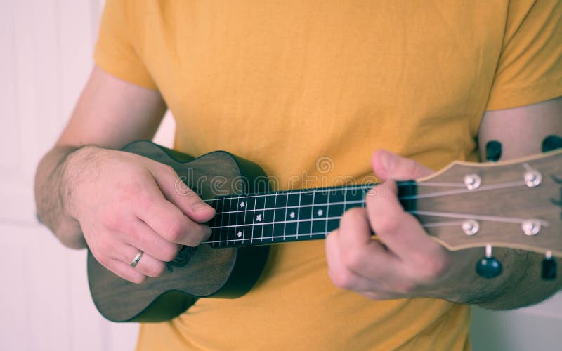 Man the Guy Playing the Ukulele Stock Photo - Image of hands, acoustic ...