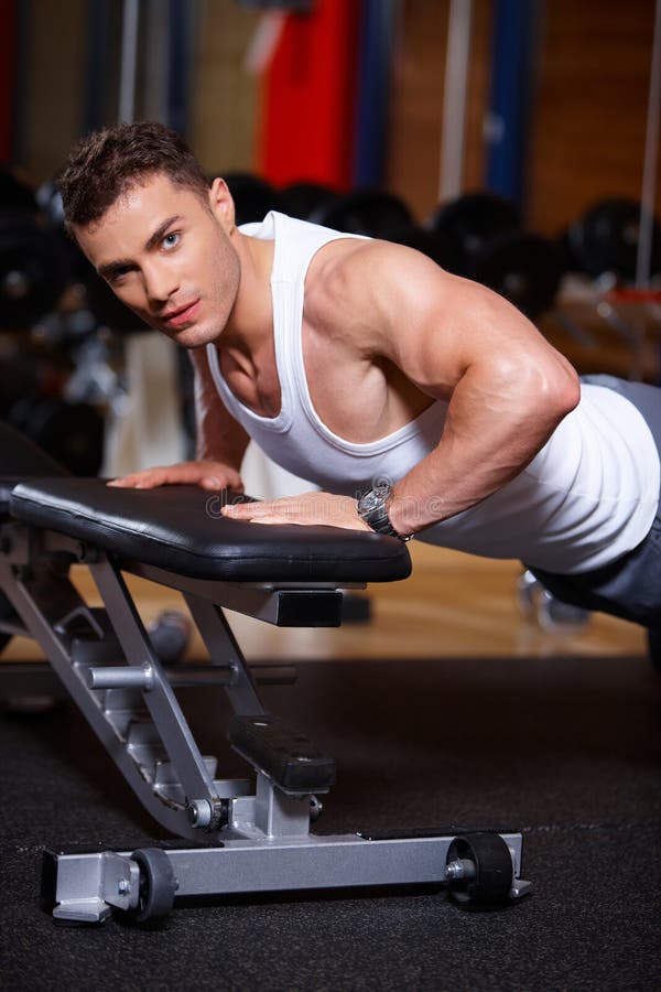 Teen Bodybuilder Exercising Pecs Muscles with Gym Equipment Stock Photo ...